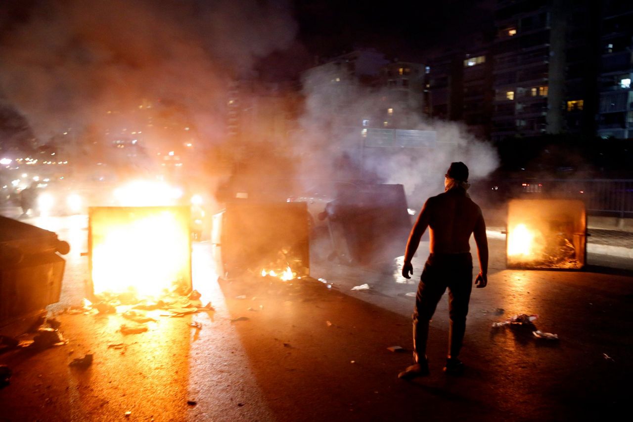 Beirut residents scuffle with protesters at city roadblock
