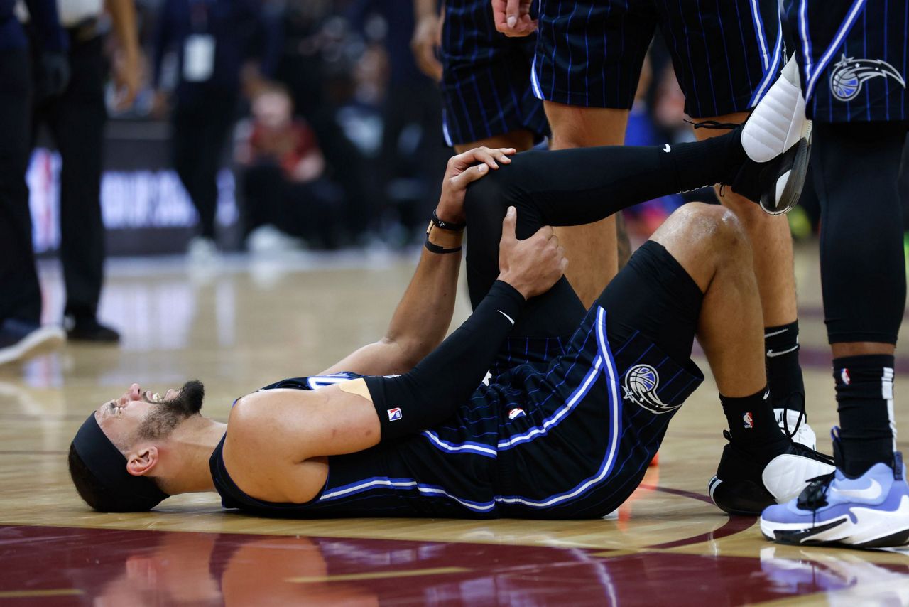 Orlando Magic guard Jalen Suggs helped off with left leg injury in Game ...