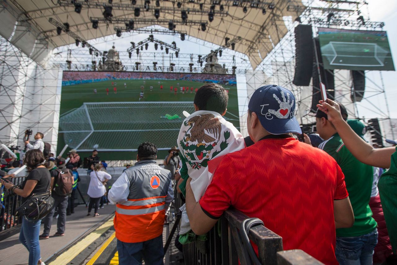 Mexican soccer fans and pride marchers mingle in celebration