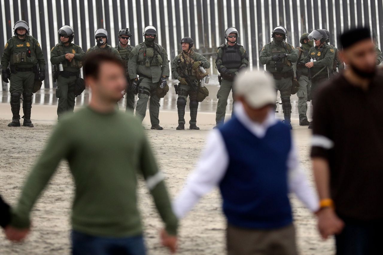 Border Patrol handcuffs demonstrators supporting migrants