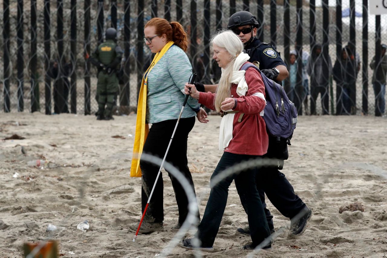 Border Patrol handcuffs demonstrators supporting migrants