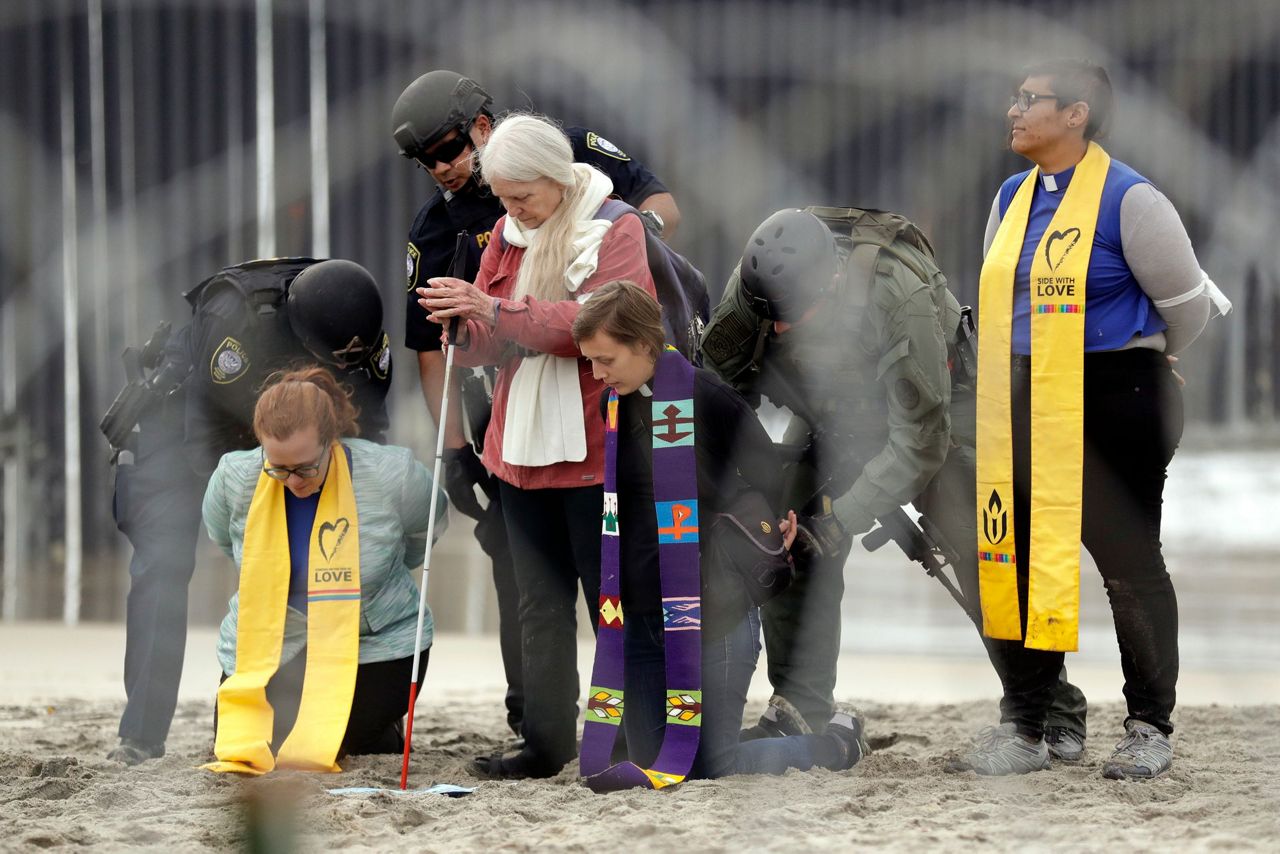 Border Patrol handcuffs demonstrators supporting migrants