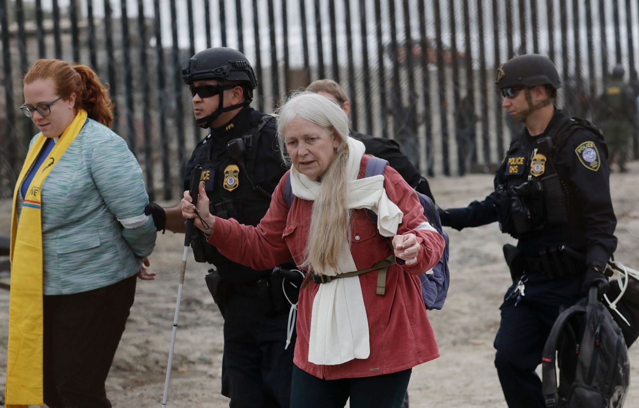 Border Patrol handcuffs demonstrators supporting migrants