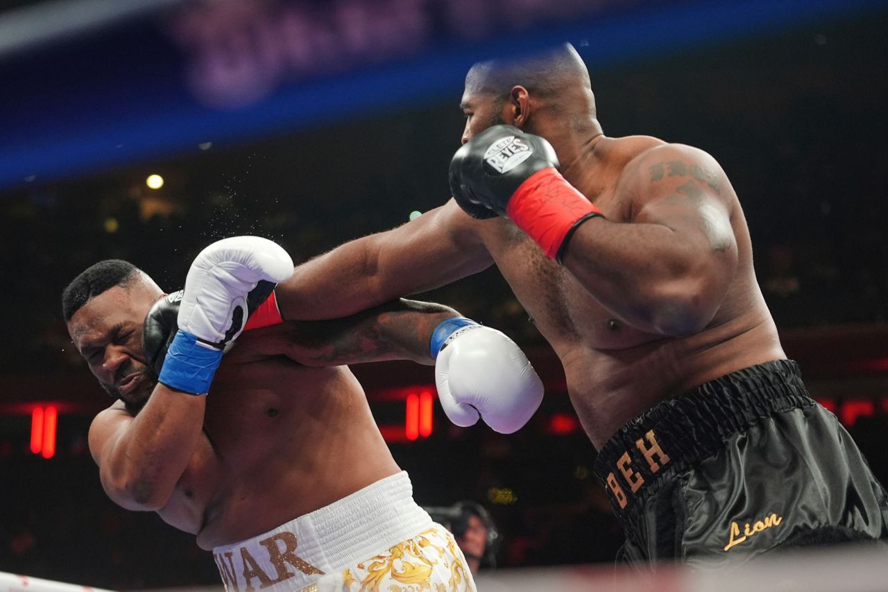Boxer Jarrell Miller has his hairpiece knocked upward by a punch, then ...