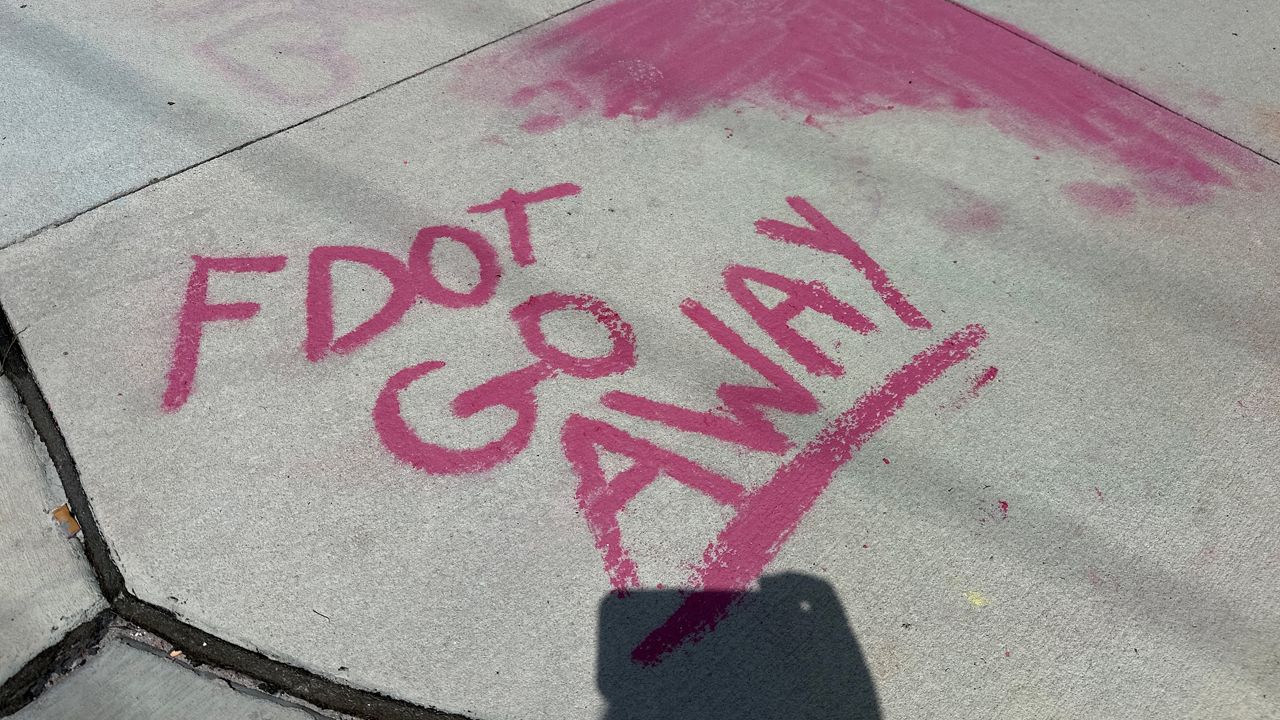 Signs posted near Pulse crosswalk warn about defacing road