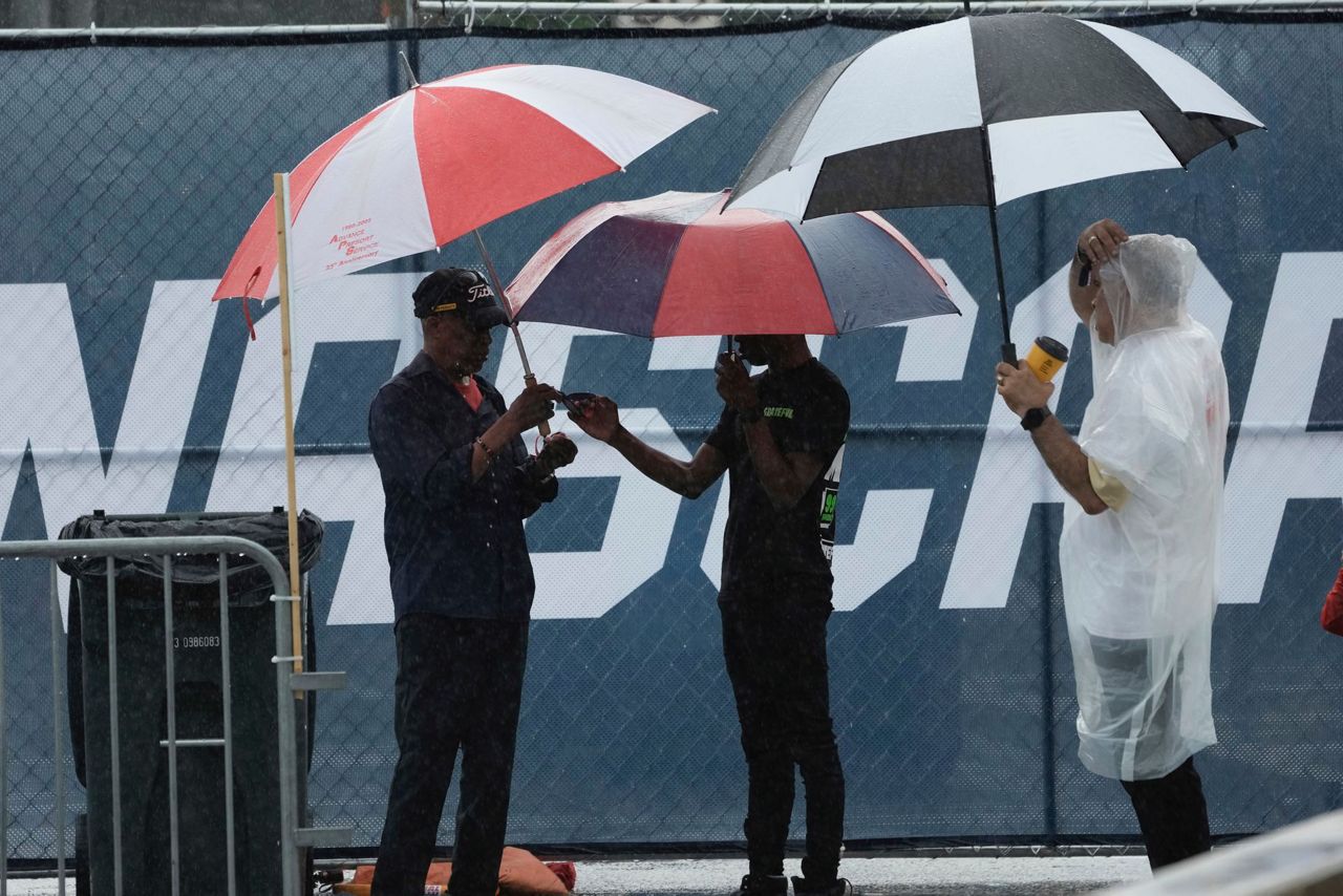 Heavy rains flood Chicago roads, NASCAR ends downtown street race and ...