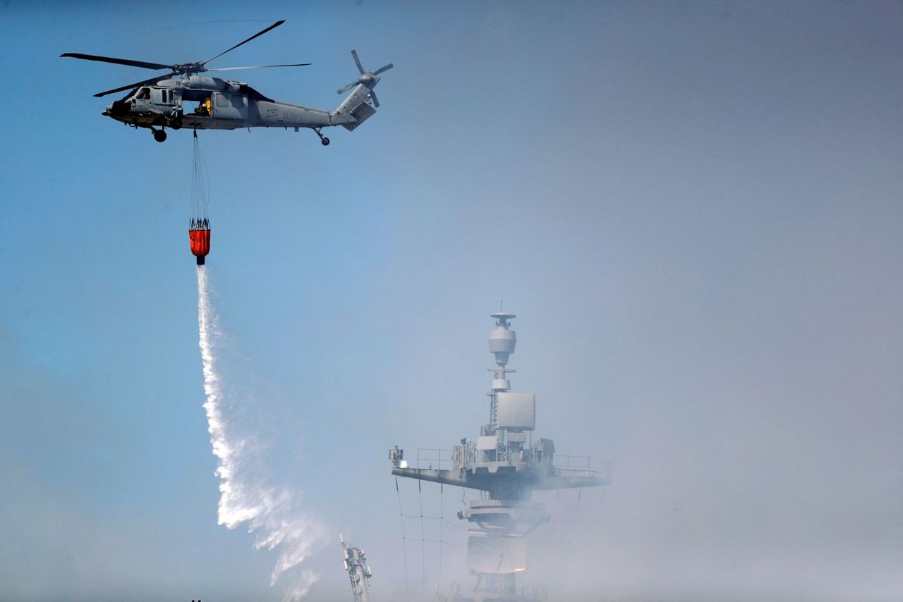 Navy charges sailor with setting fire that destroyed warship