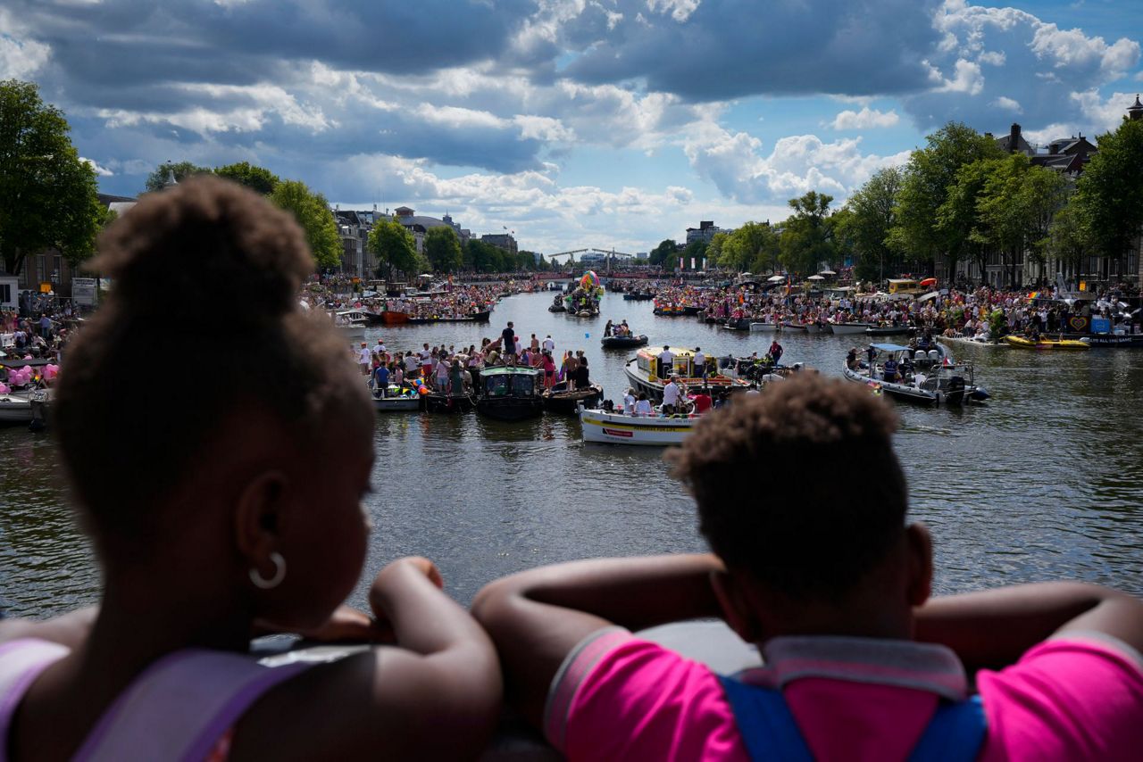 Huge crowds watch Amsterdam Pride's canal parade celebration