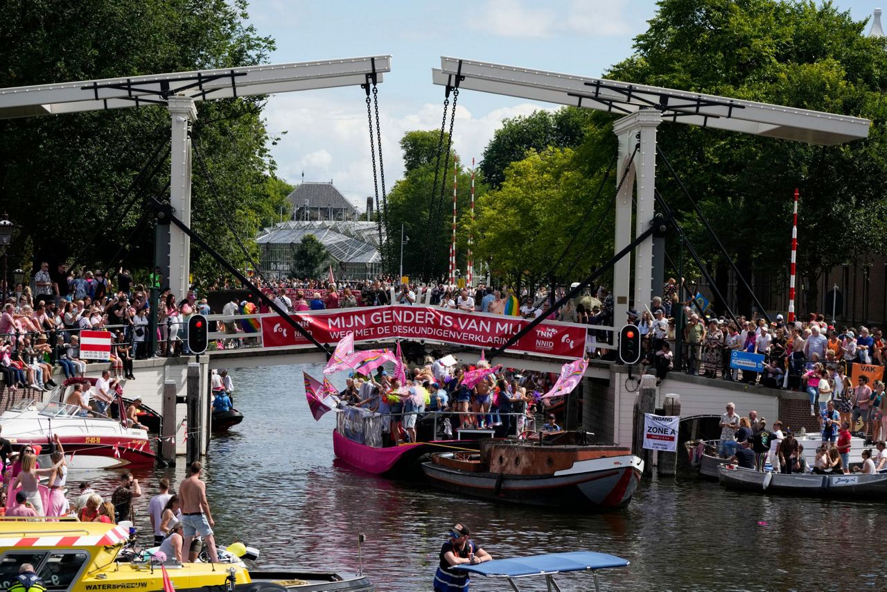 Huge crowds watch Amsterdam Pride's canal parade celebration