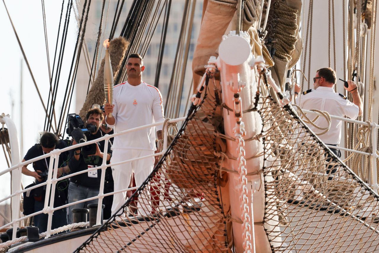 A ship carrying the Olympic torch arrives in Marseille amid fanfare and ...