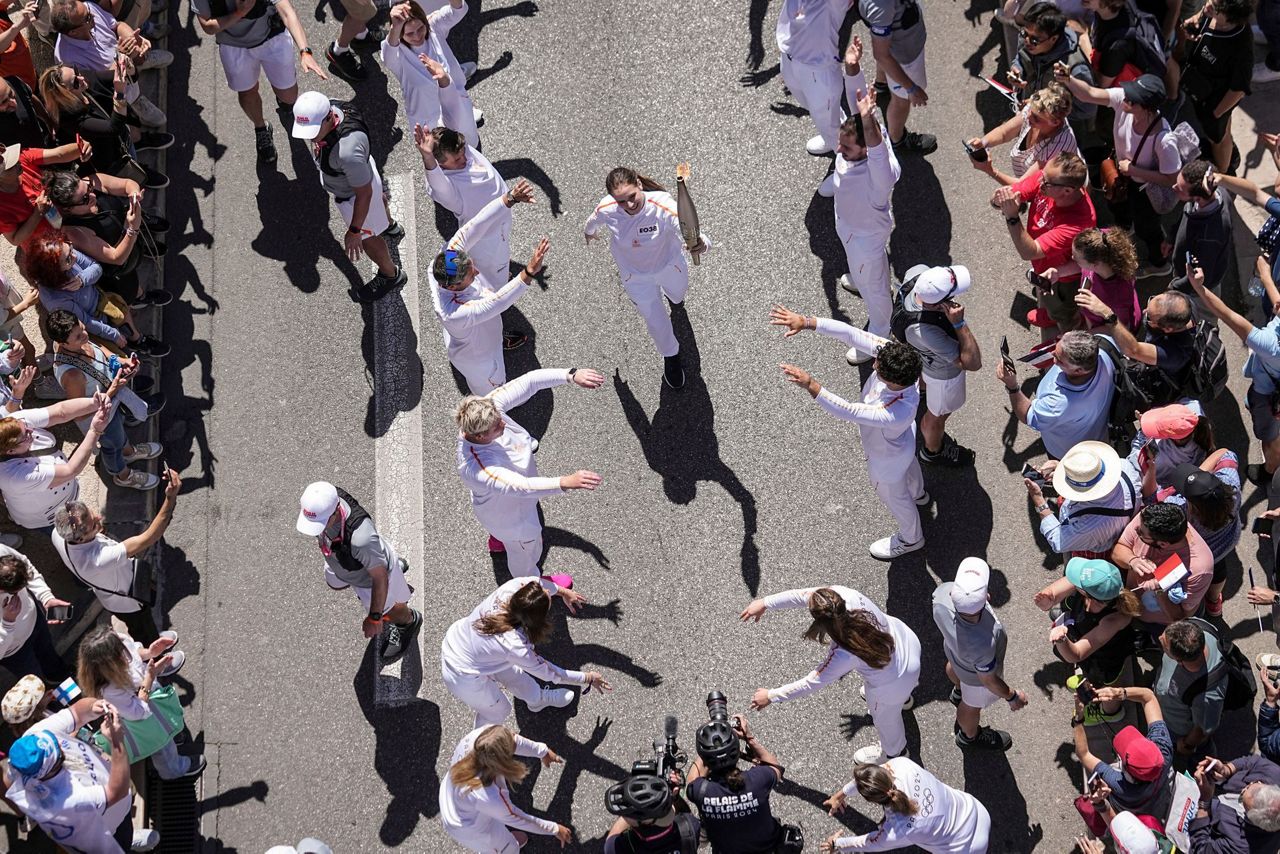 A Ukrainian gymnast carried the Paris Olympic torch with an EU team, in ...