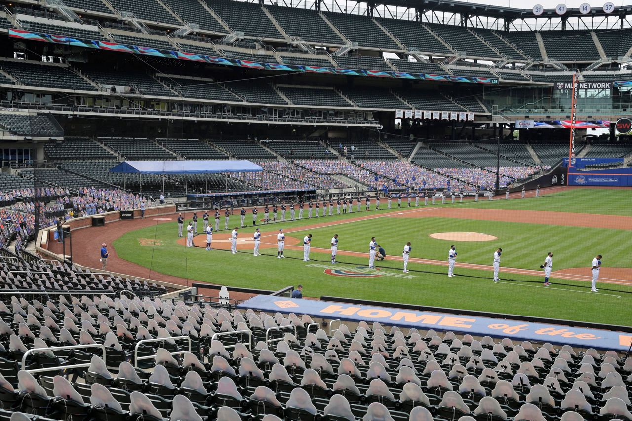 AP PHOTOS: Empty stands, masked players as baseball returns