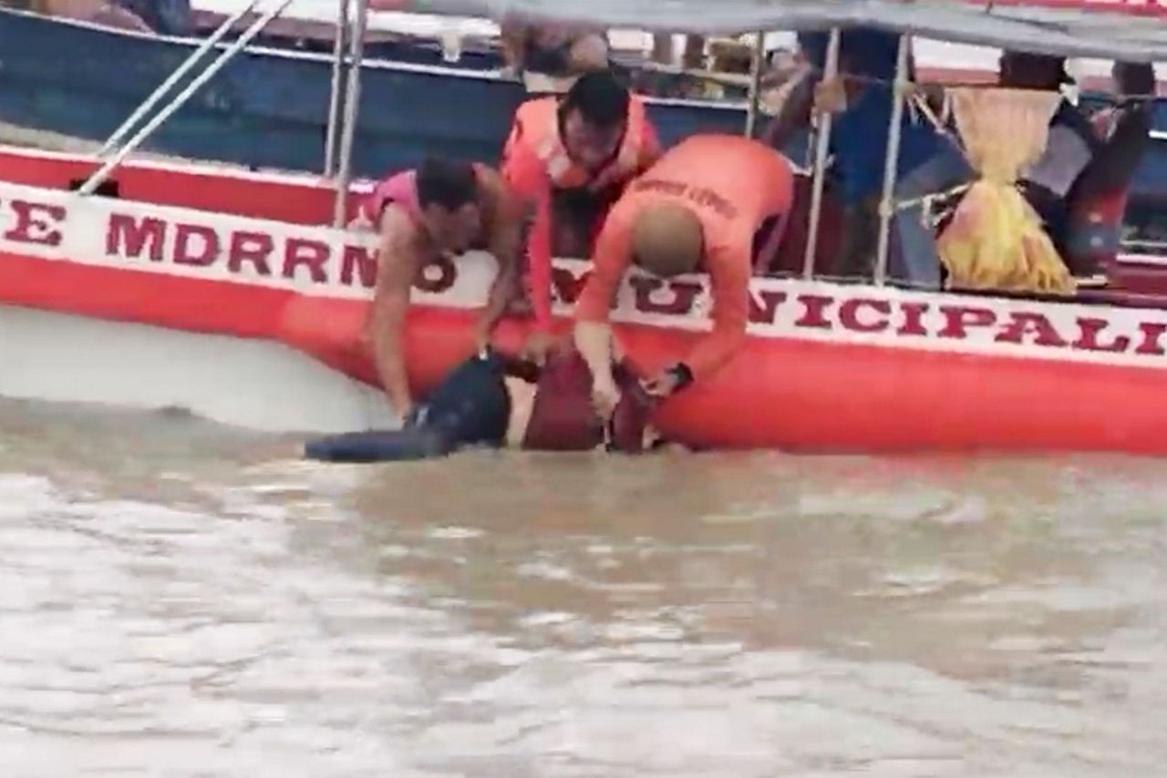 Wind-tossed boat with dozens of people aboard overturns in Philippines ...