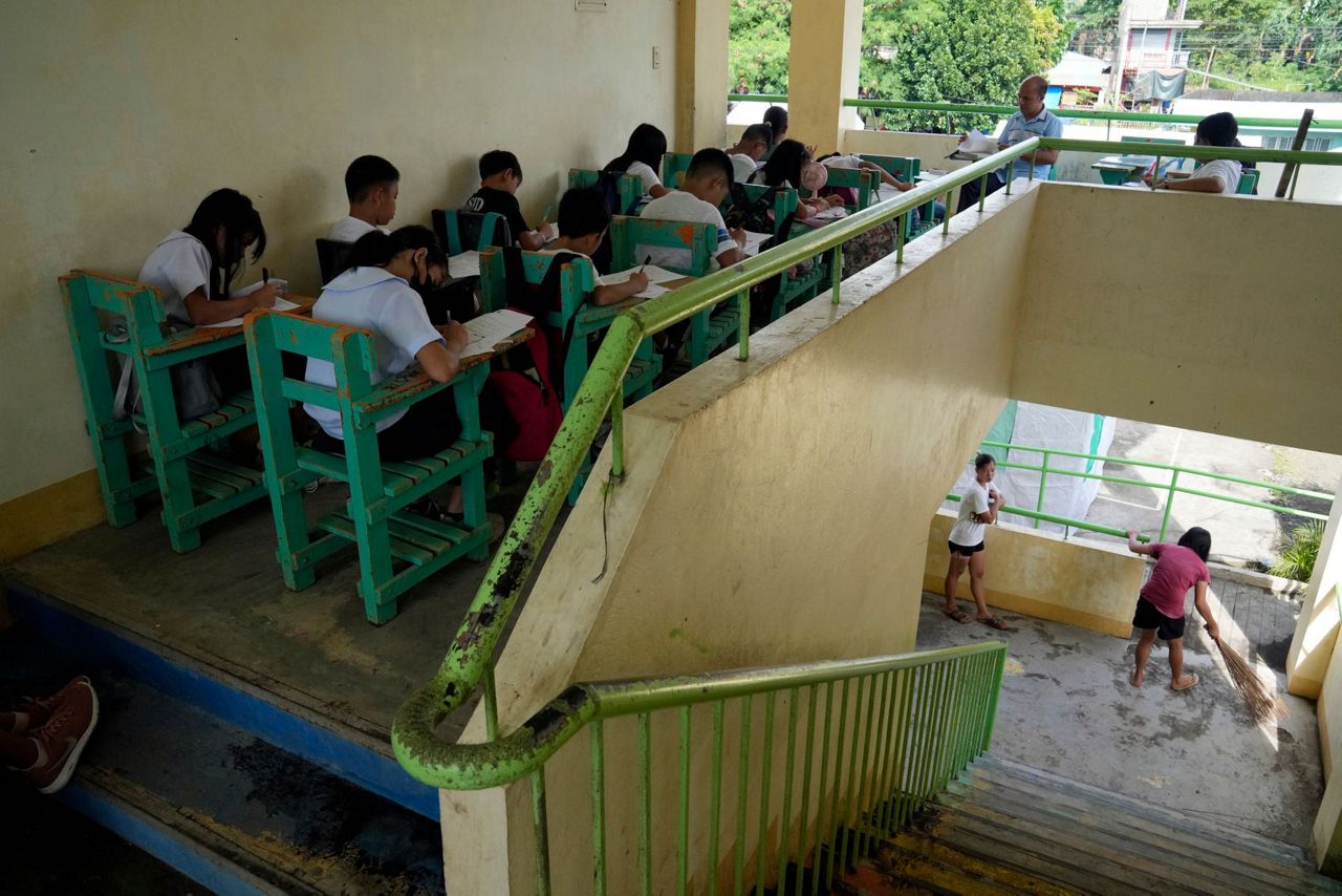 Students meet under trees as schools shelter villagers displaced by ...
