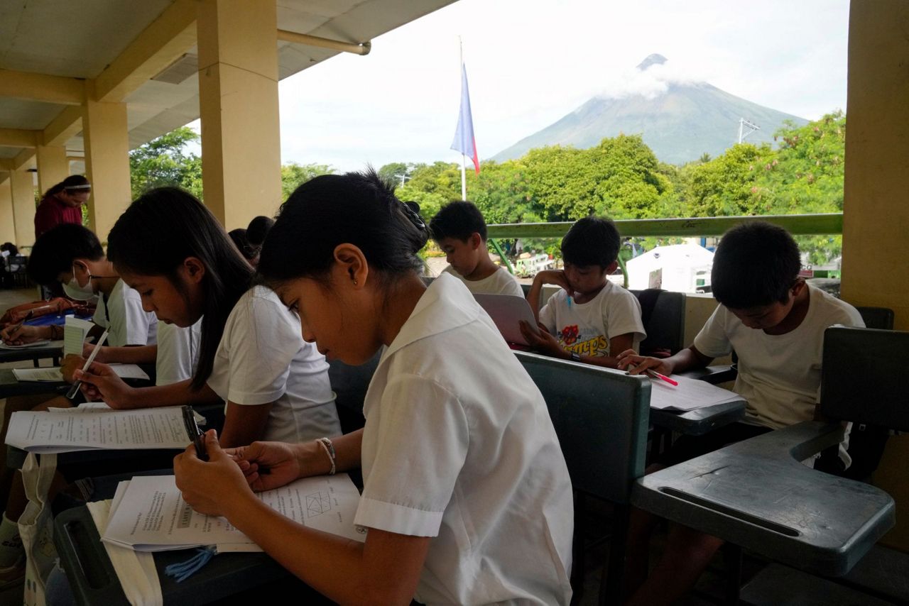 Students meet under trees as schools shelter villagers displaced by ...