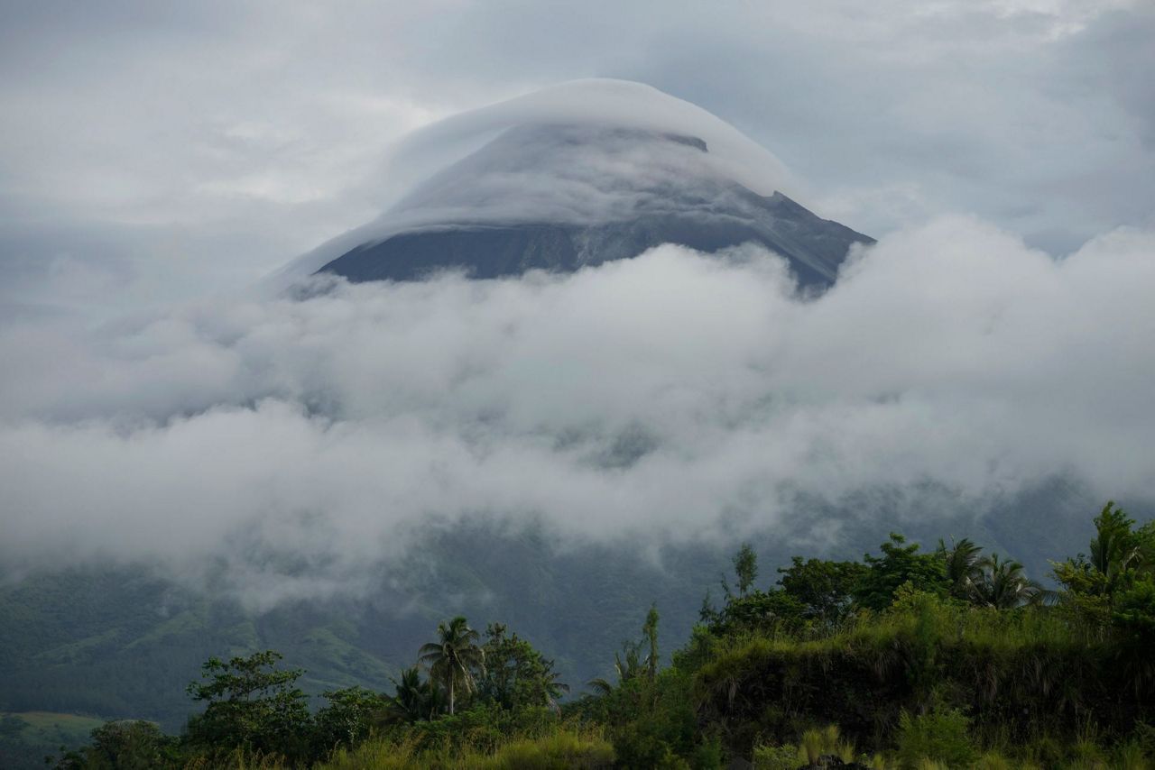 Philippines' Mayon Volcano spews lava down its slopes in gentle ...