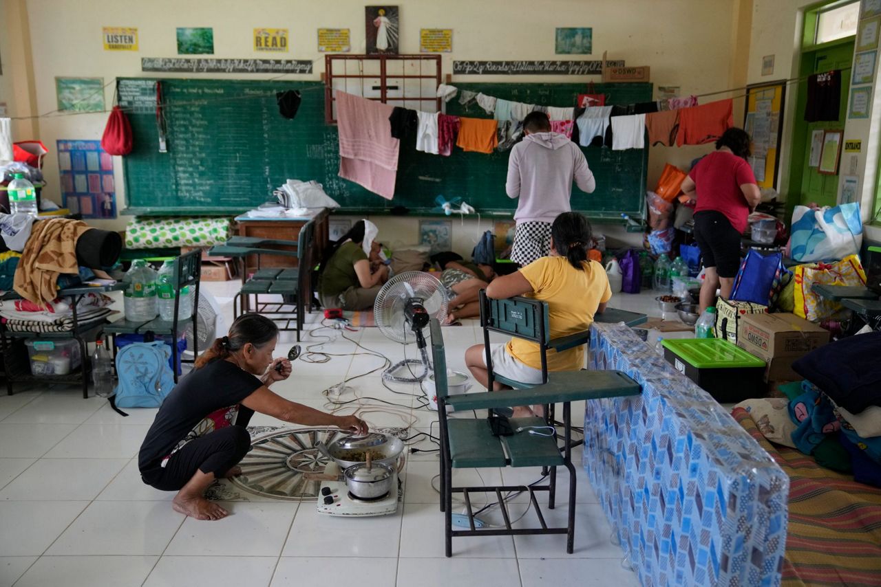 Students meet under trees as schools shelter villagers displaced by ...
