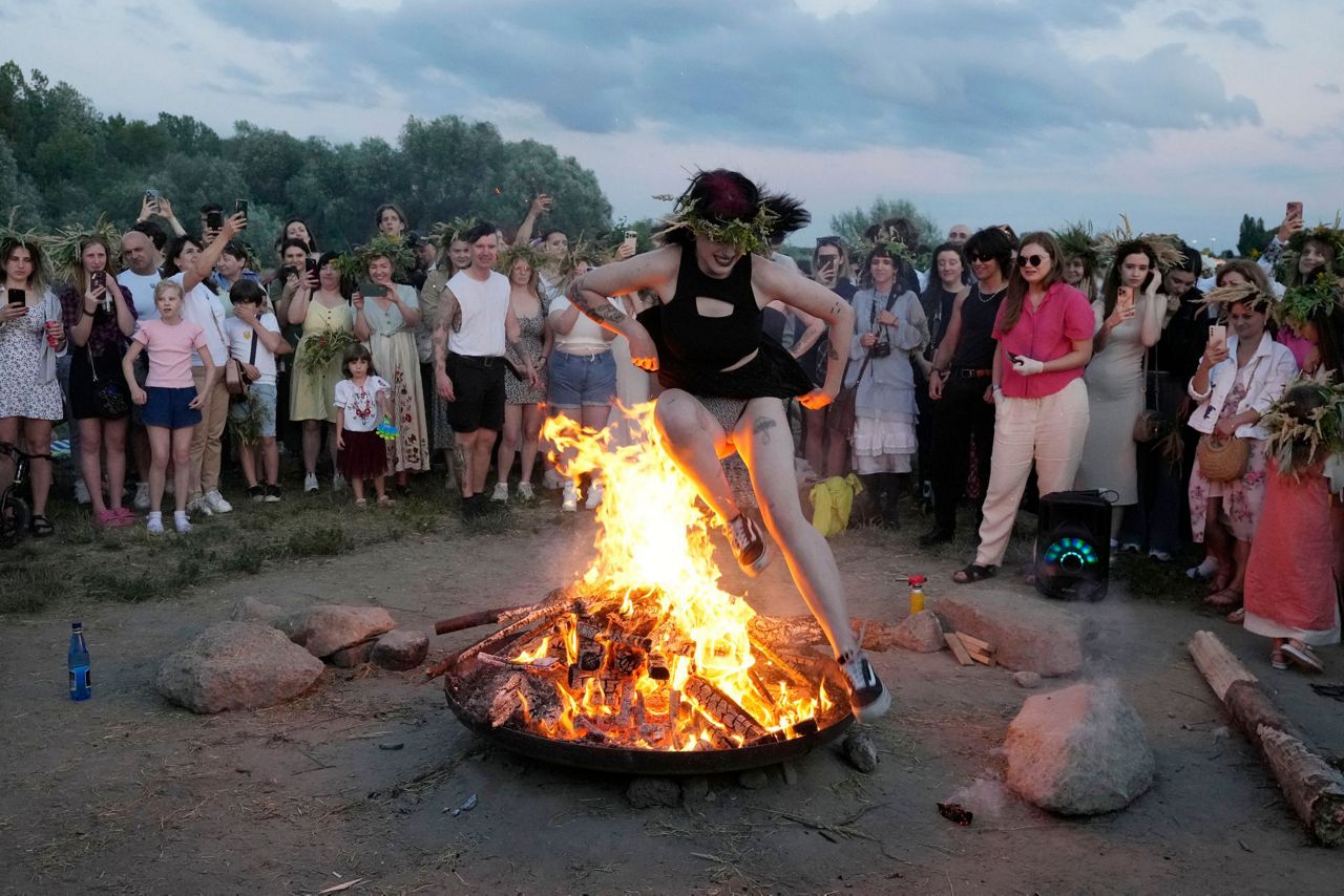 Ukrainians in Warsaw jump over a bonfire, float braids to celebrate solstice custom away from home