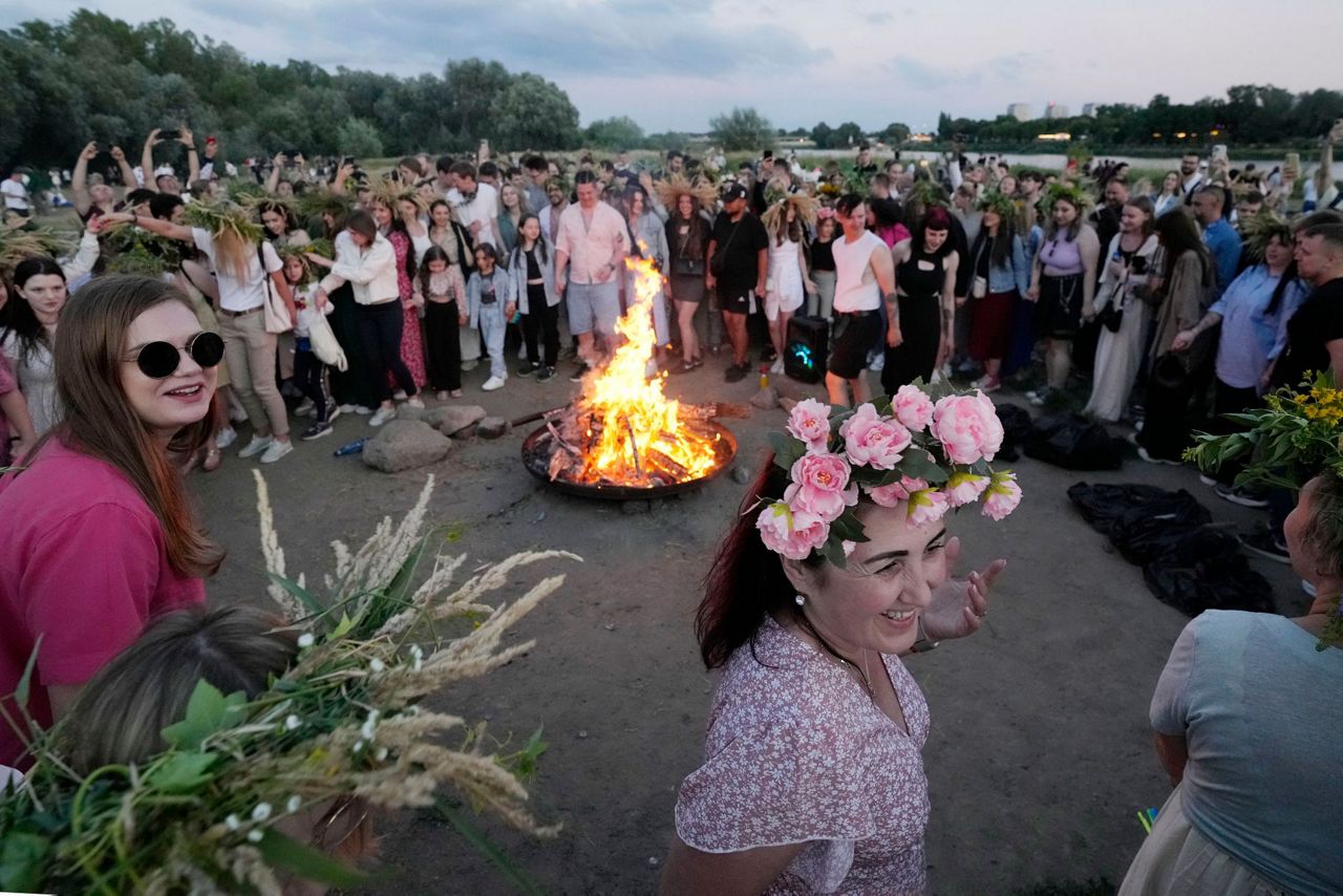 Ukrainians in Warsaw jump over a bonfire, float braids to celebrate ...
