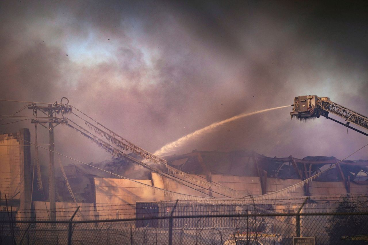 Crews battle flames, cold, wind in huge recycling plant fire