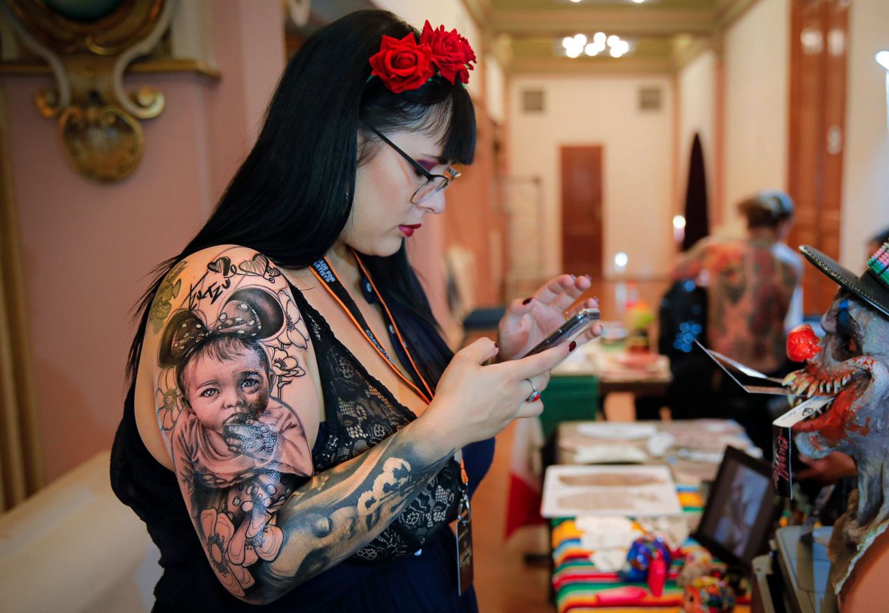 AP PHOTOS: Cream of tattoos on show at Romanian palace