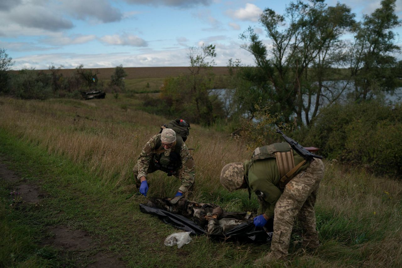 In Ukraine's retaken battlefields, soldiers recover bodies