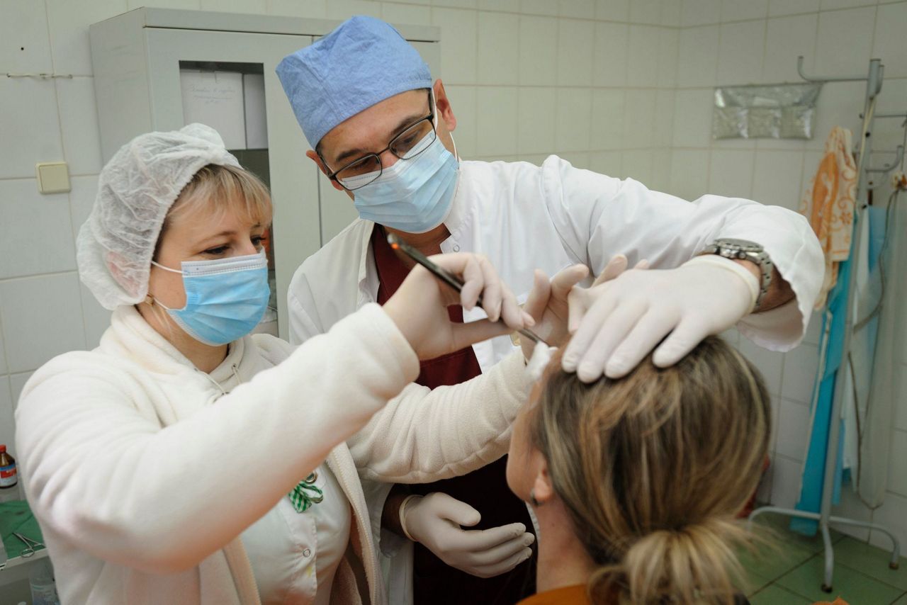 Surgeons work by flashlight as Ukraine power grid battered
