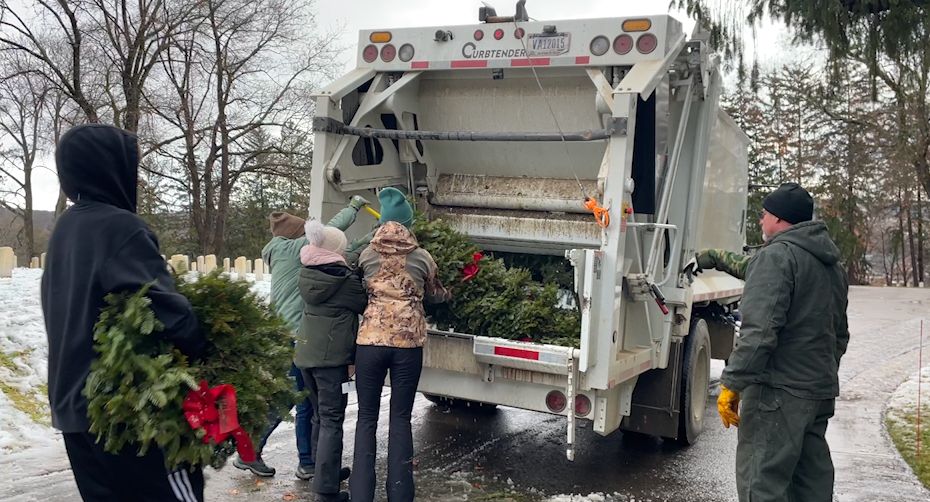 Volunteers retrieve wreaths from Bath National Cemetery