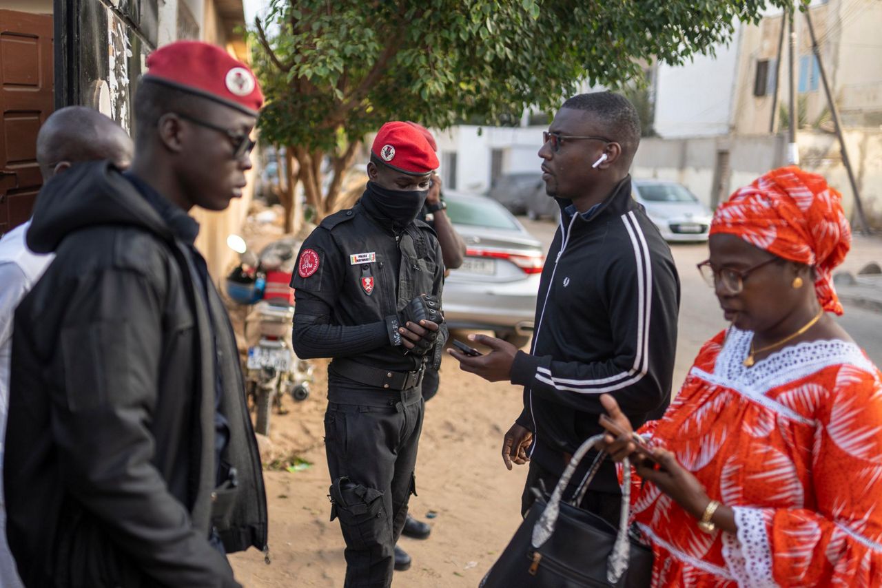 Senegal votes in a tightly contested presidential race after months of ...