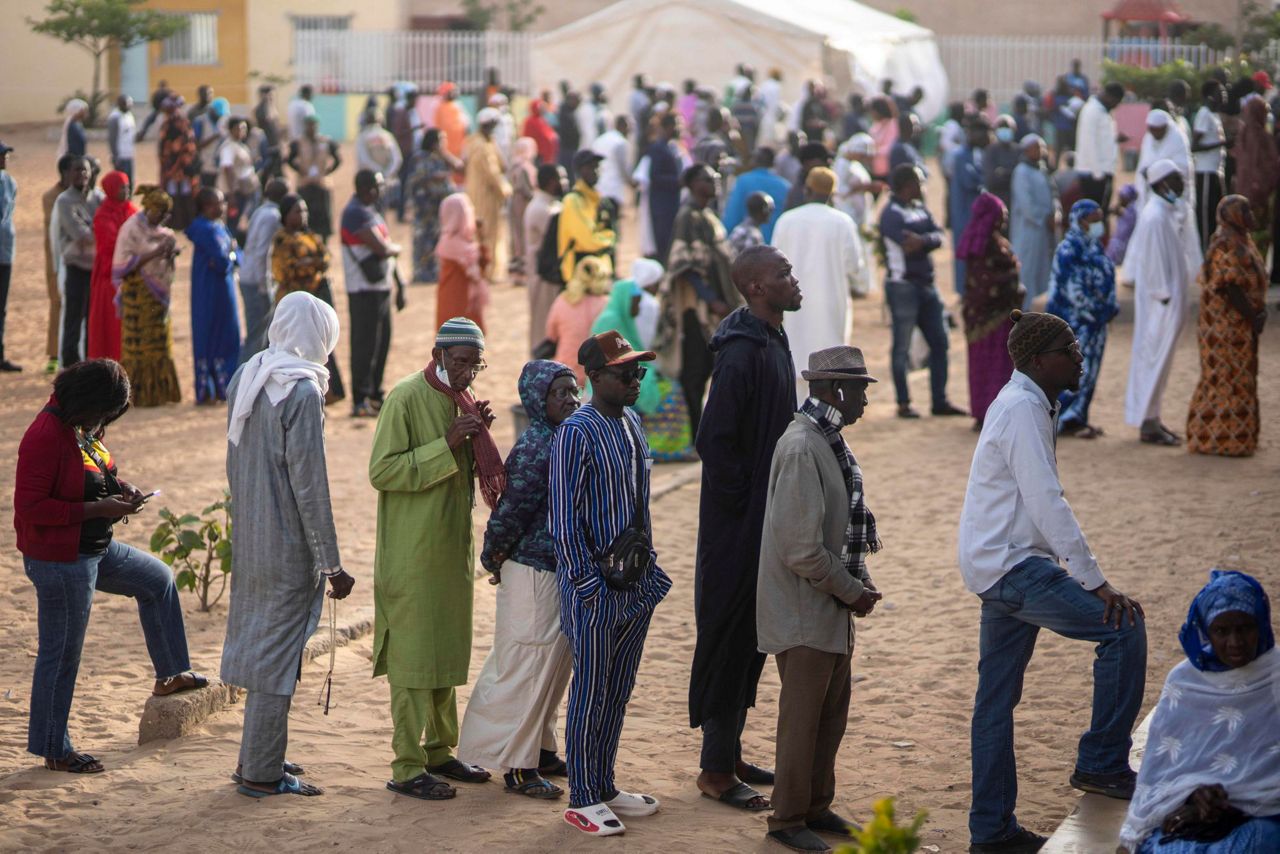 Senegal votes in a tightly contested presidential race after months of ...