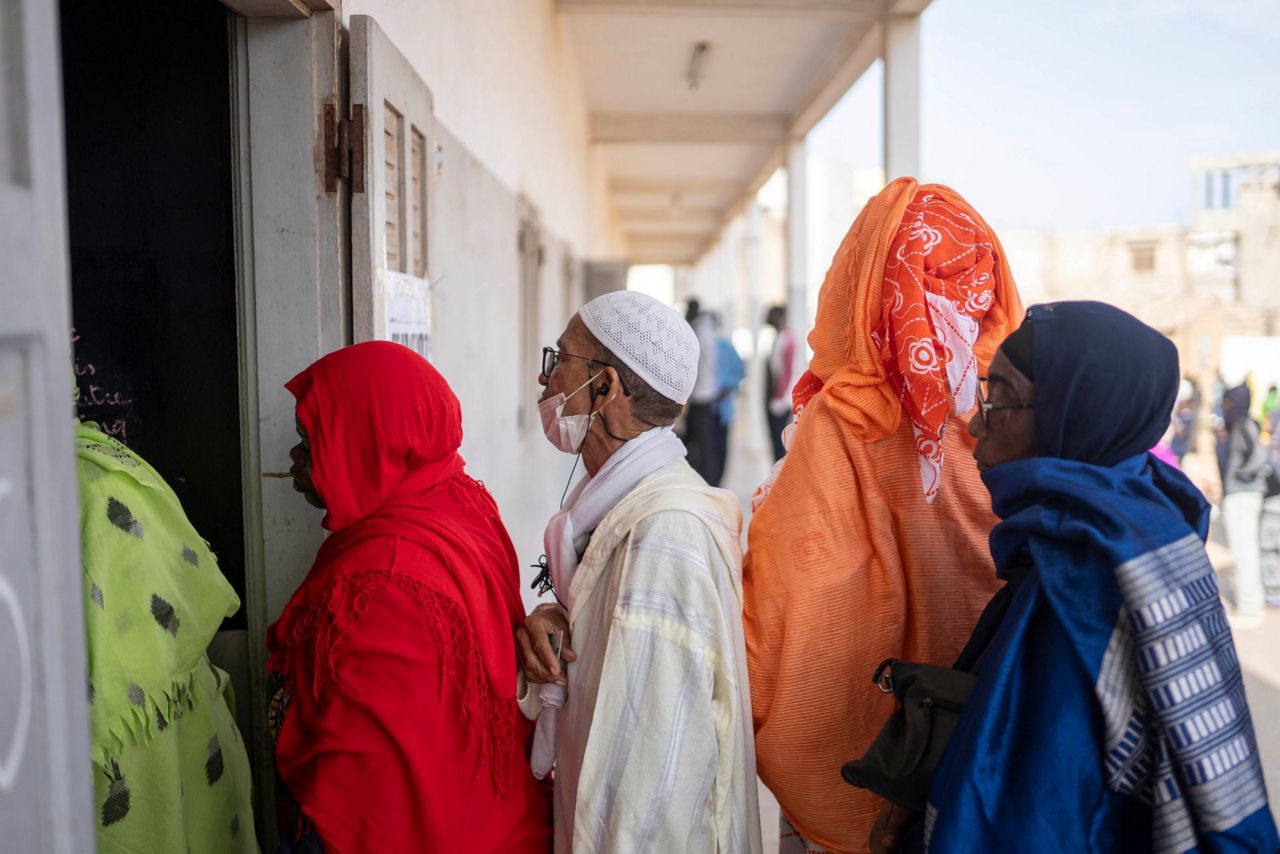 Senegal votes in a tightly contested presidential race after months of ...