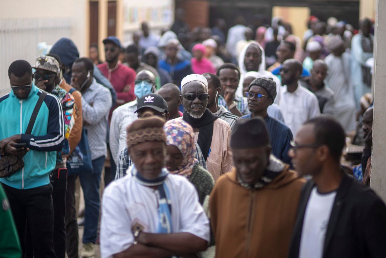 Senegal votes in a tightly contested presidential race after months of ...