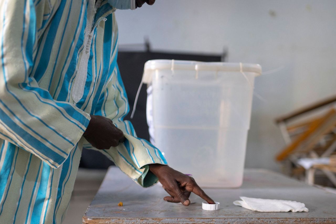 Senegal votes in a tightly contested presidential race after months of ...