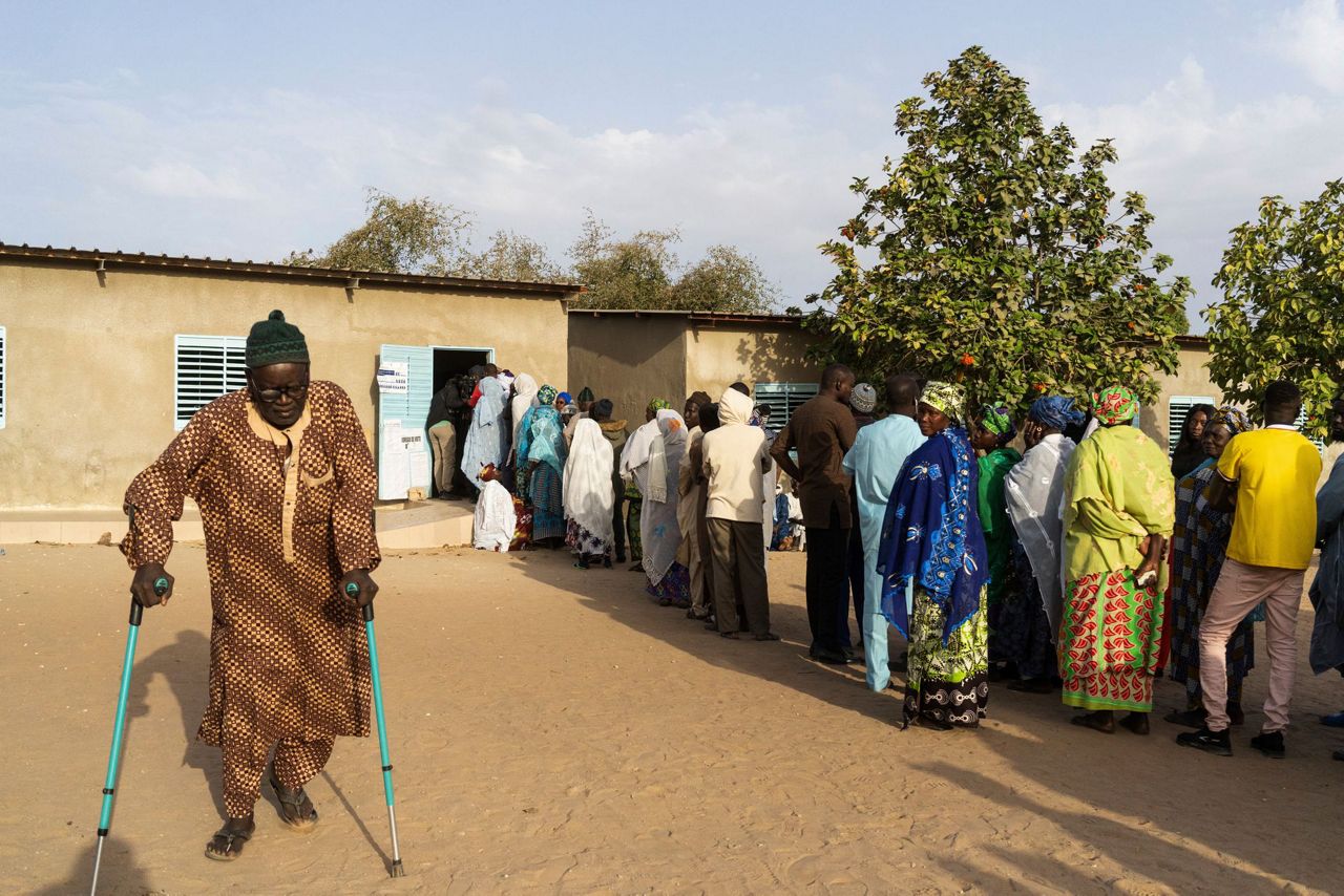 Senegal votes in a tightly contested presidential race after months of ...