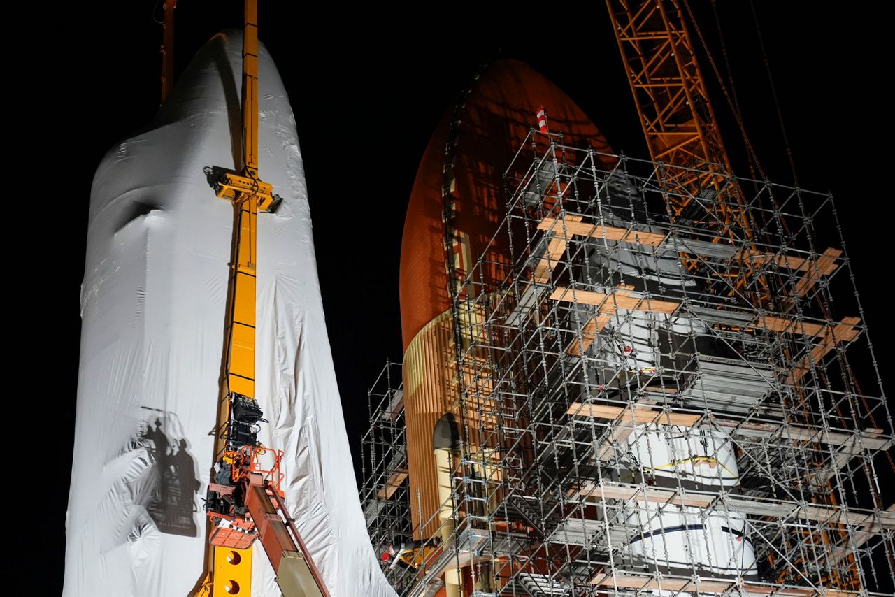 Space Shuttle Endeavour hoisted for installation in vertical display at ...