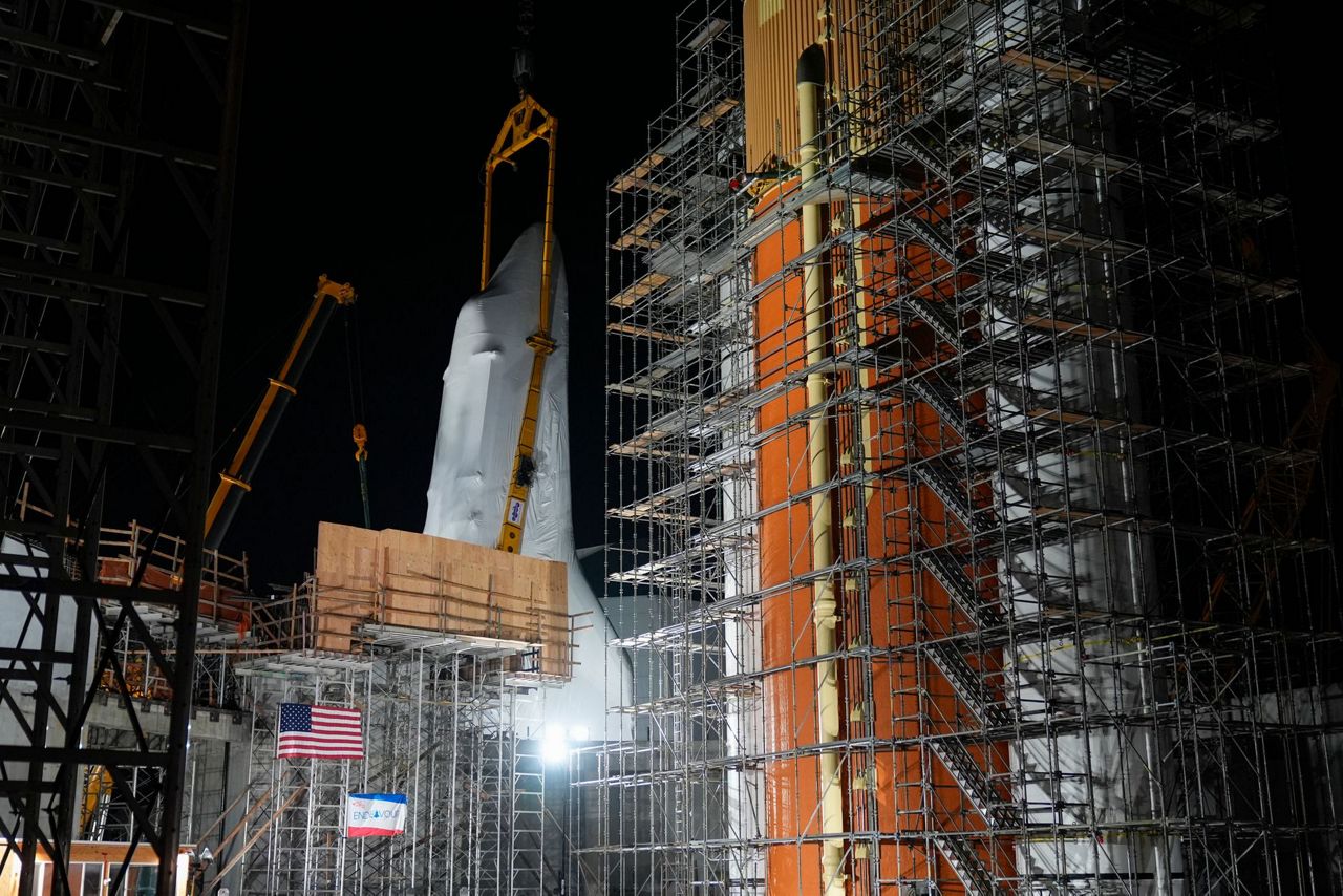 Space Shuttle Endeavour hoisted for installation in vertical display at ...