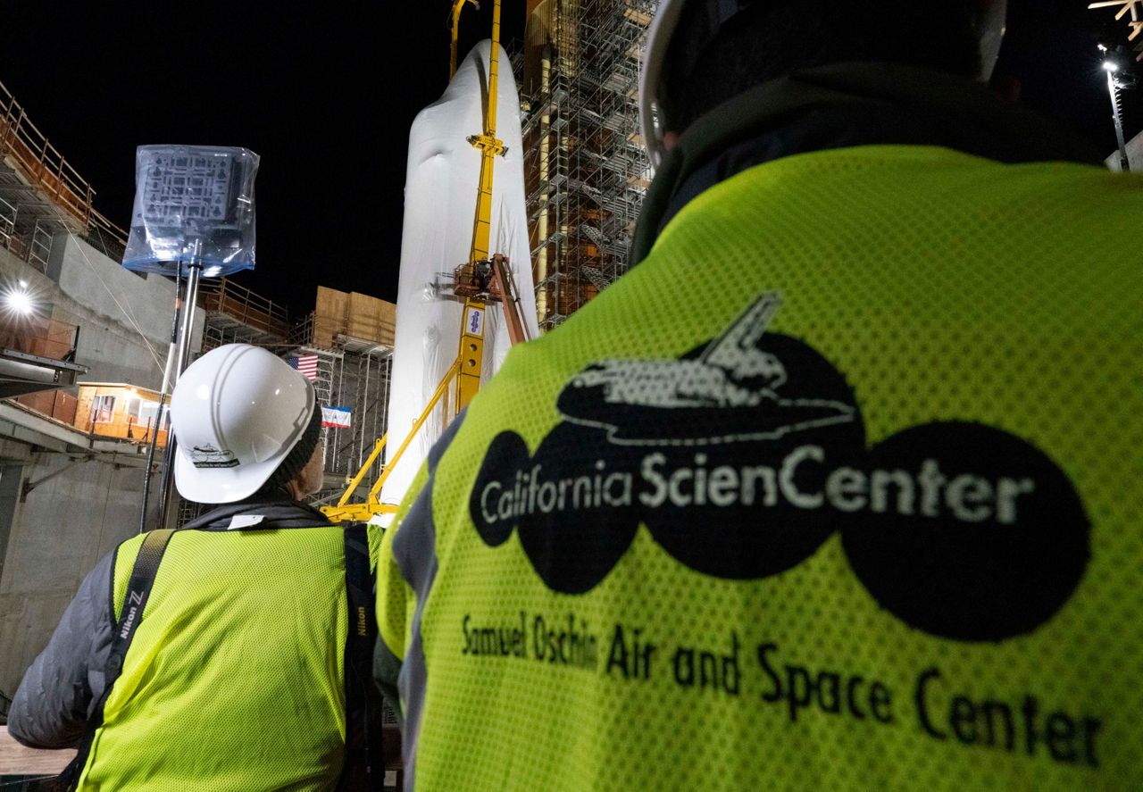 Space Shuttle Endeavour hoisted for installation in vertical display at ...
