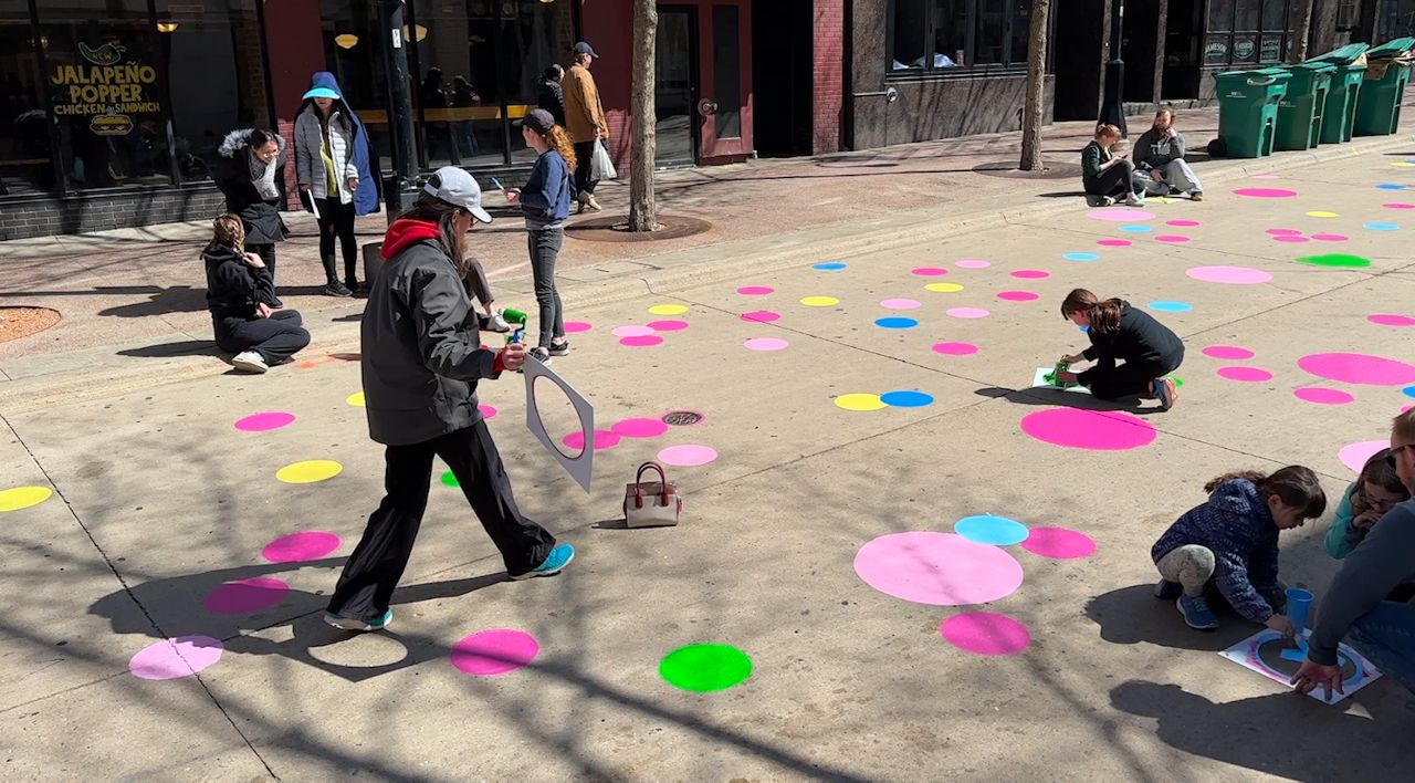 Over 600 people create street art on State Street in Madison