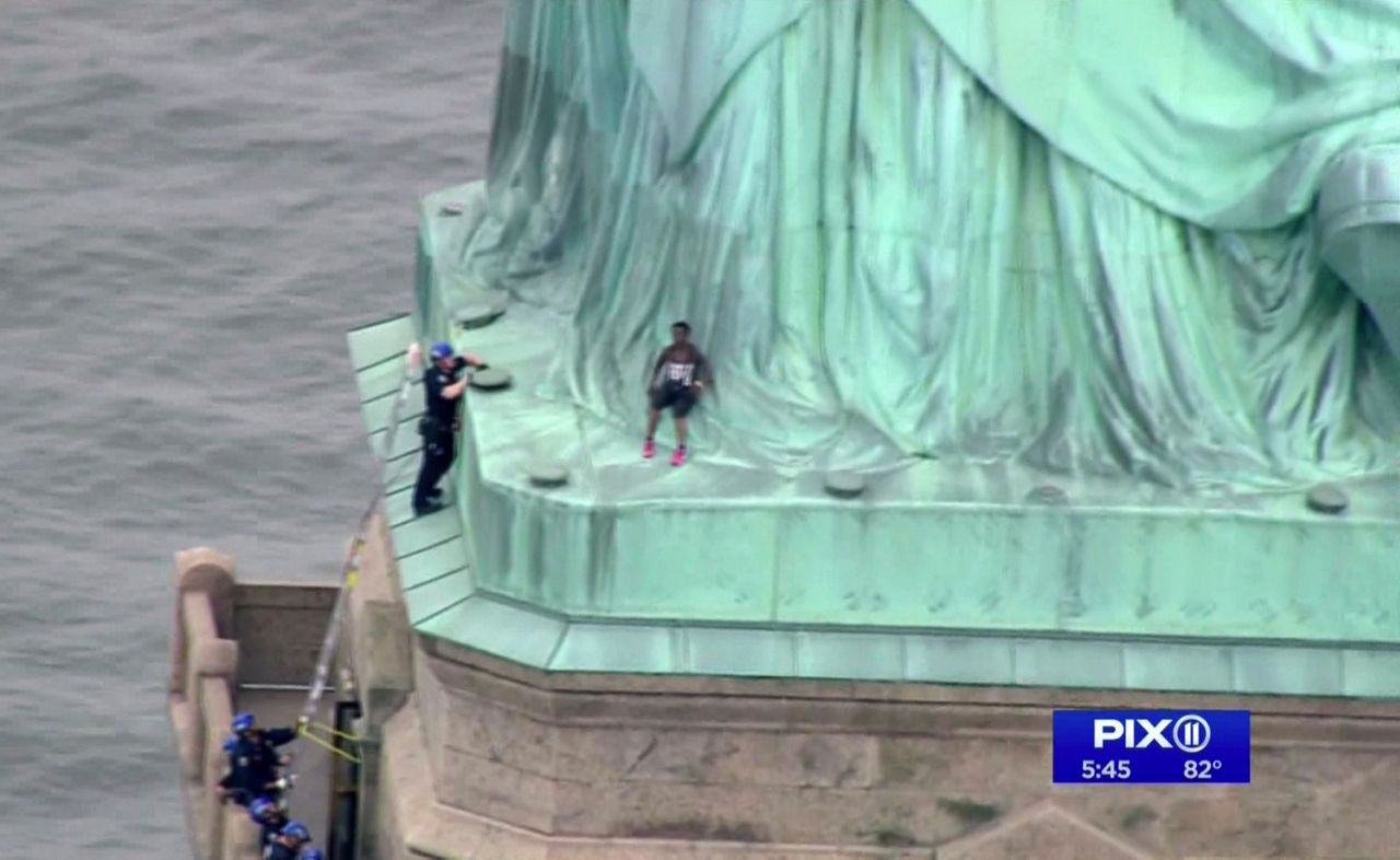 Arrests after 'Abolish ICE' sign hung from Statue of Liberty