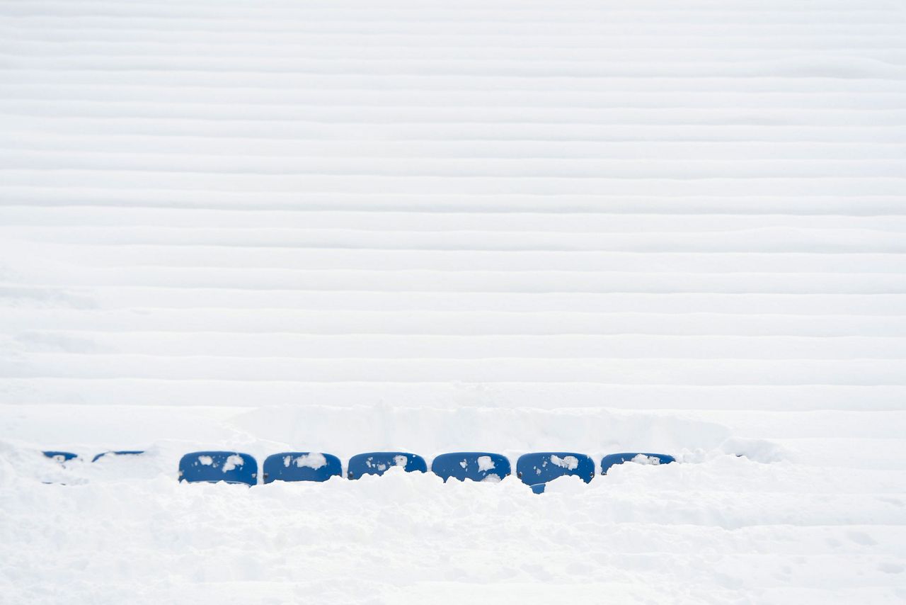 Sun is out and crews are busy digging out snow-covered stadium for ...