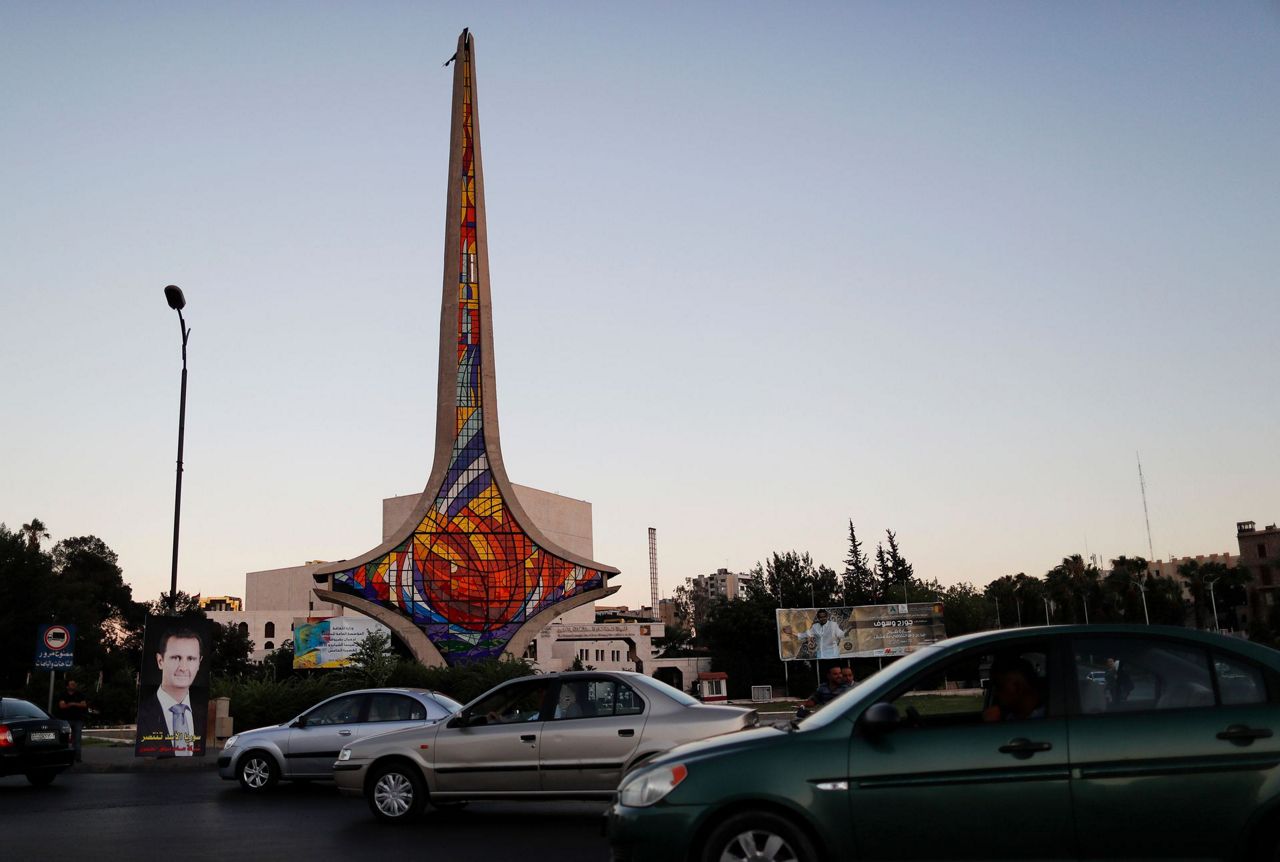 AP PHOTOS: Assad's victory posters crowd Damascus streets