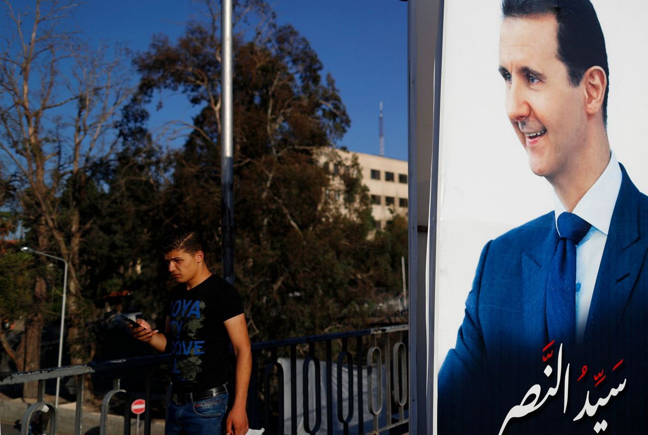 AP PHOTOS: Assad's victory posters crowd Damascus streets