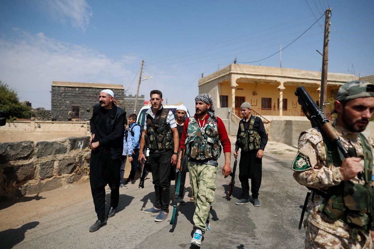 In Syria's Sweida, young taking up arms to defend villages