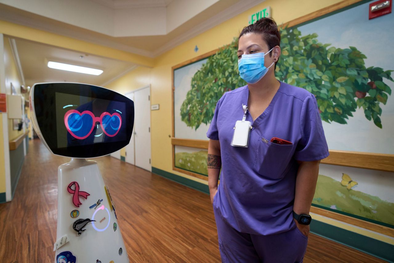 A robot programmed to act like a 7-year-old girl works to combat fear ...