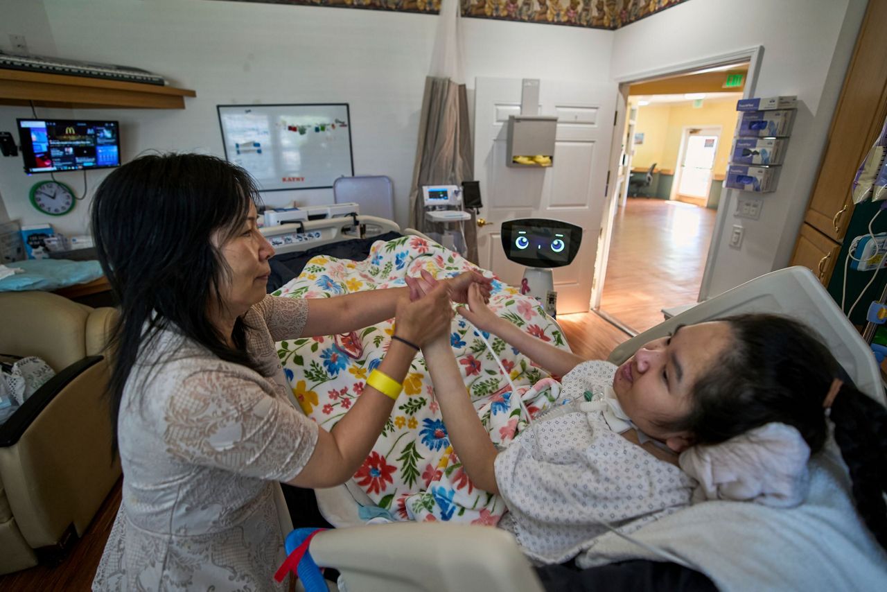 A robot programmed to act like a 7-year-old girl works to combat fear ...
