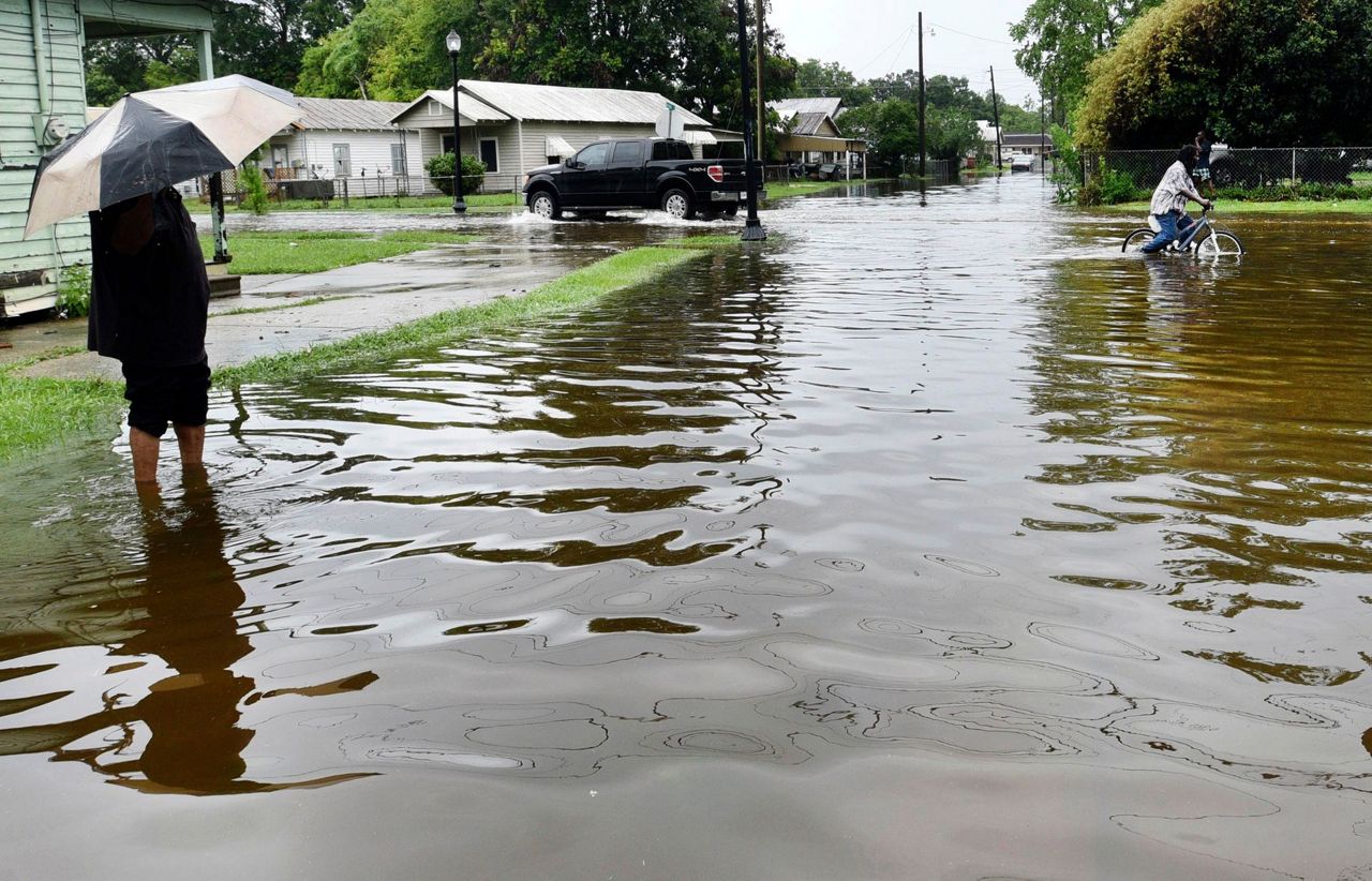 Weakened Barry still poses flood, tornado risks