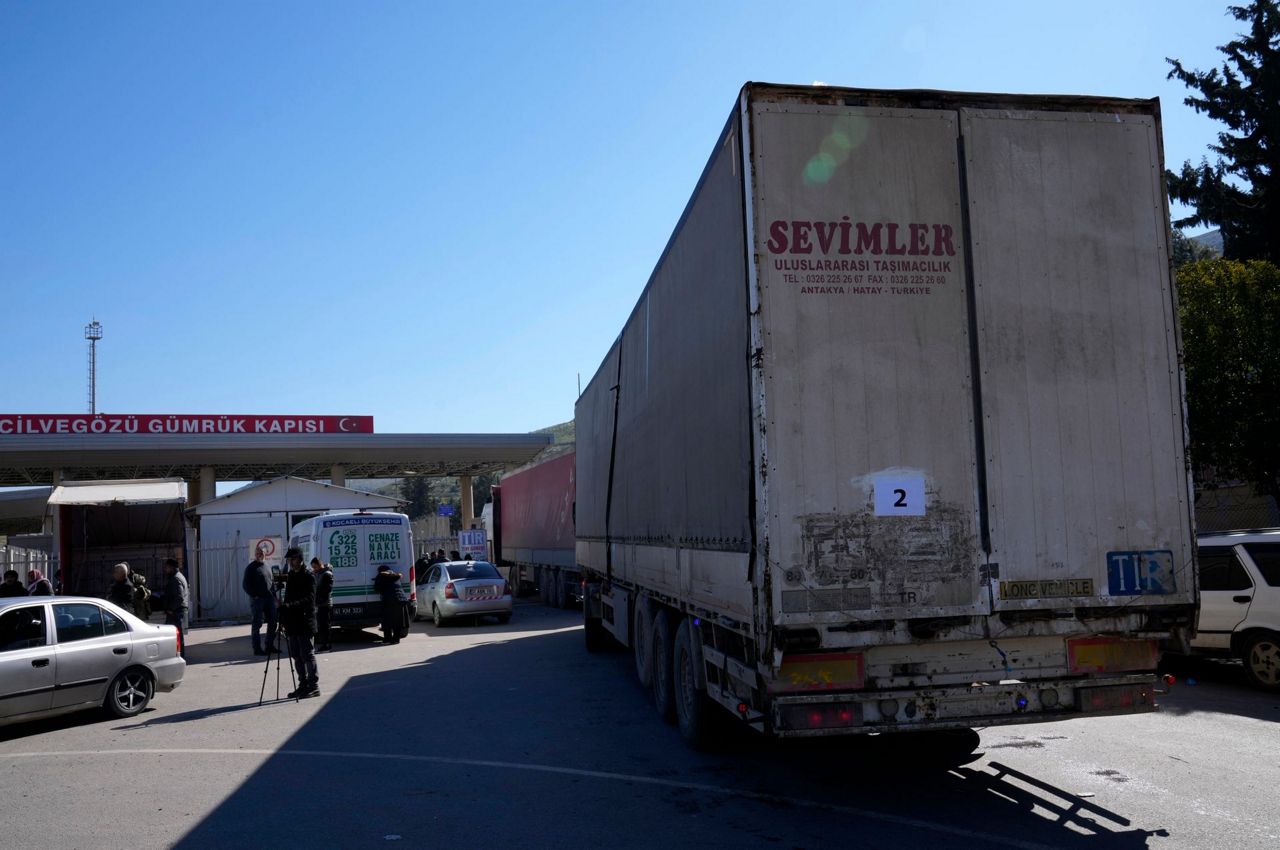 Days after quake, aid trucks reach northwest Syrian enclave