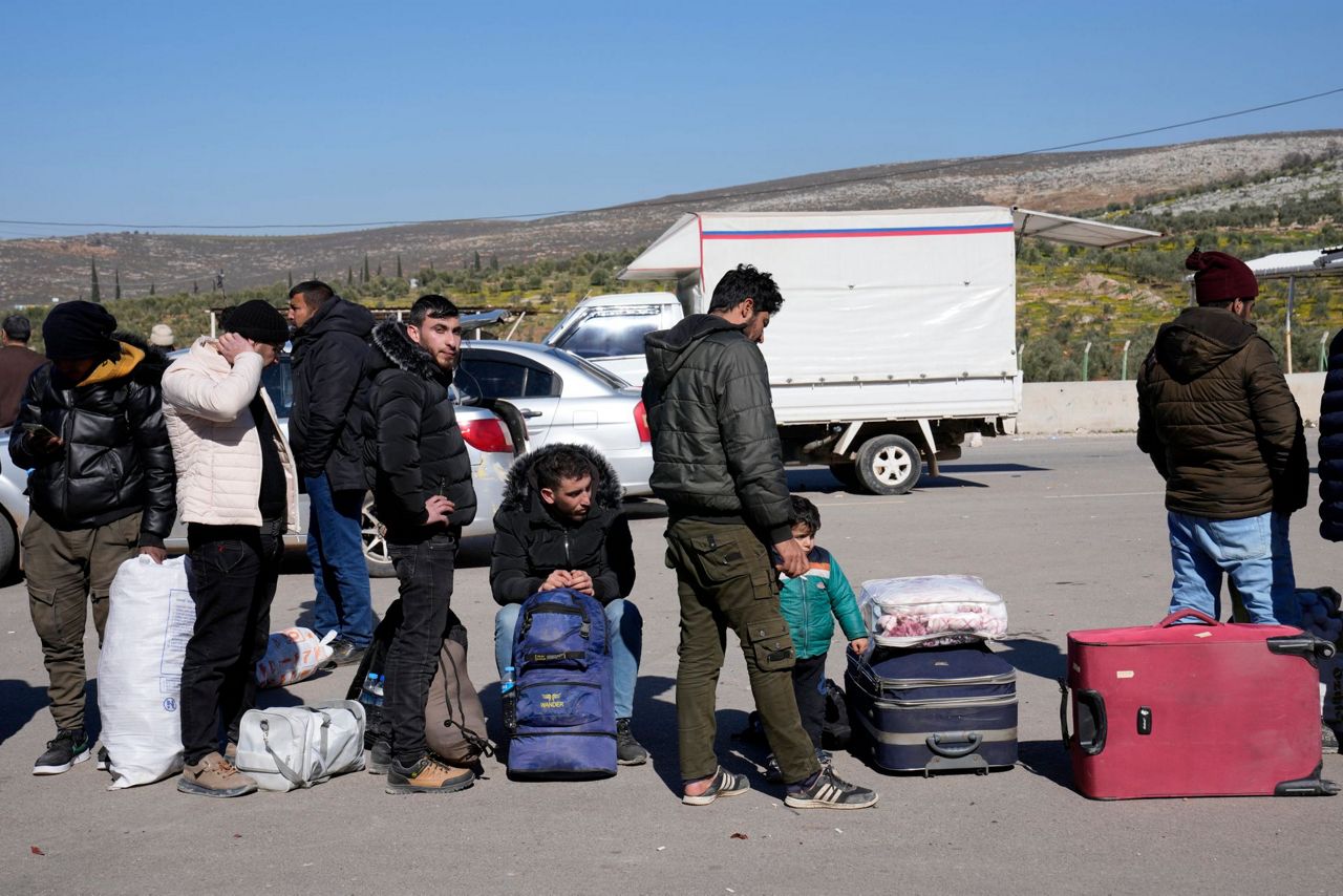 Days after quake, aid trucks reach northwest Syrian enclave
