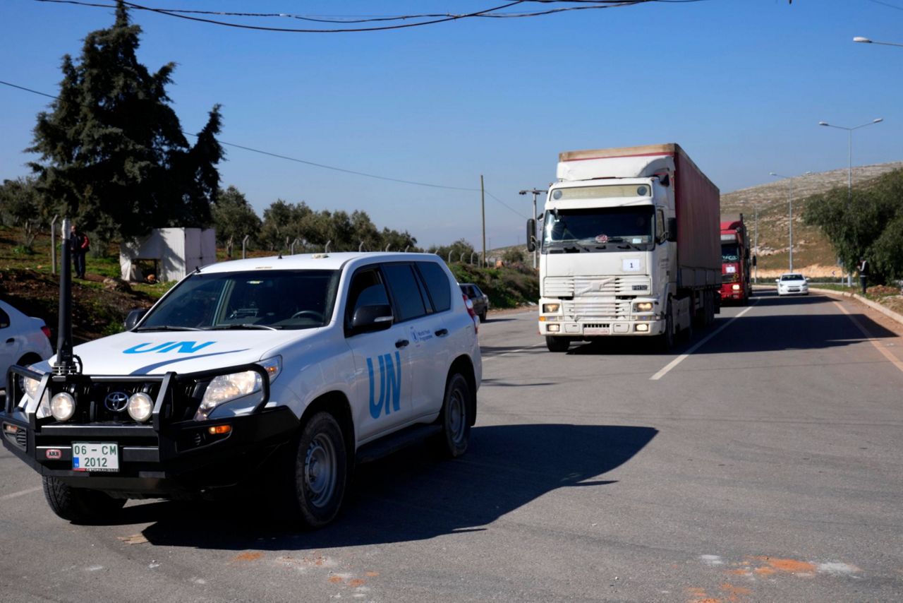Days after quake, aid trucks reach northwest Syrian enclave