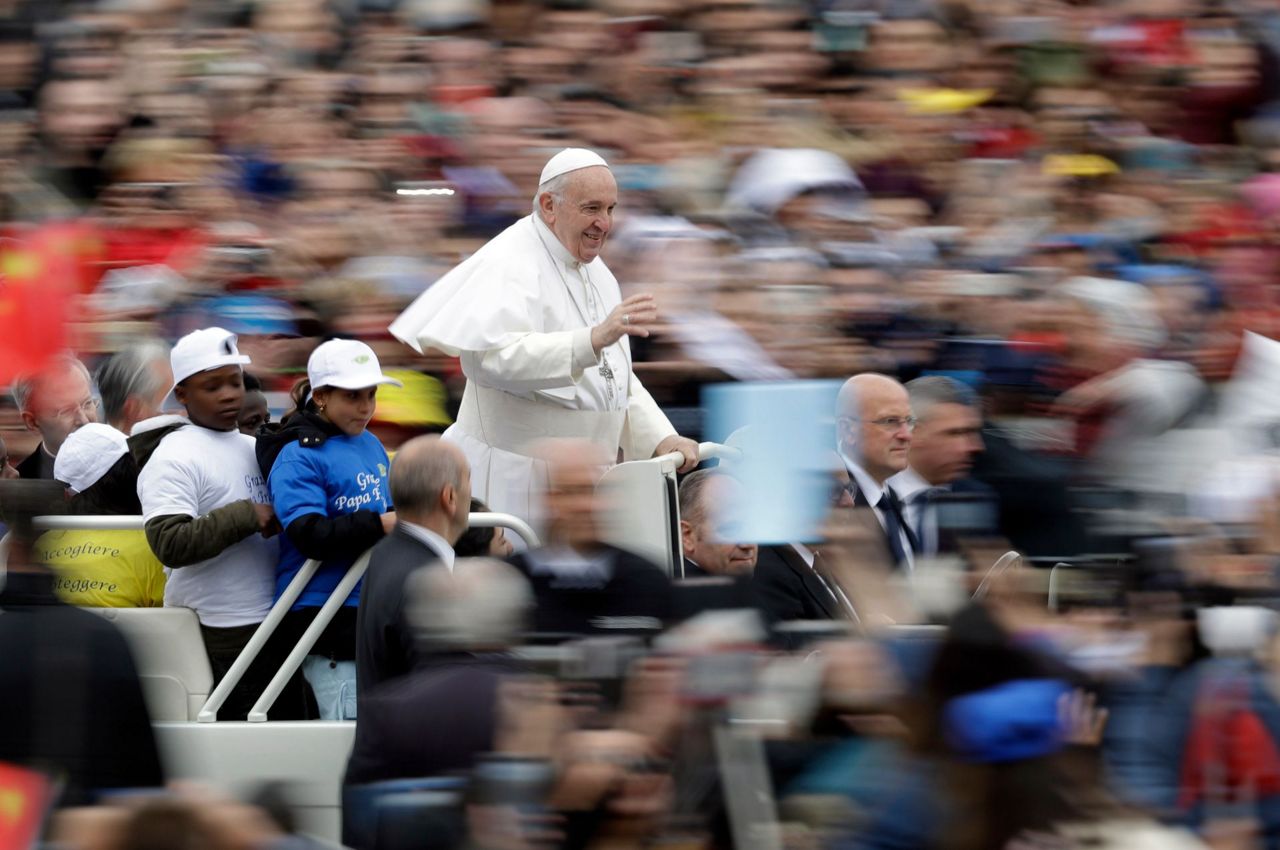 Pope gives joyride to migrant kids newly arrived in Italy